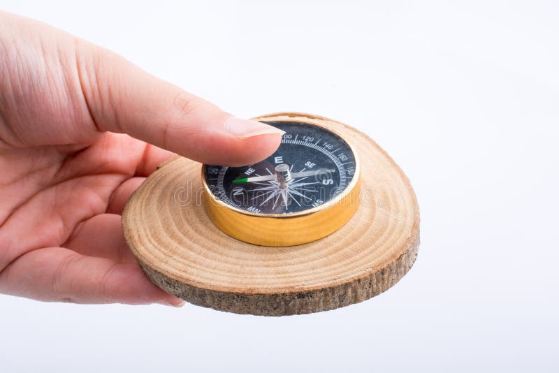 Compass on a Wood Log Cut in Round Thin Pieces on White Background ...