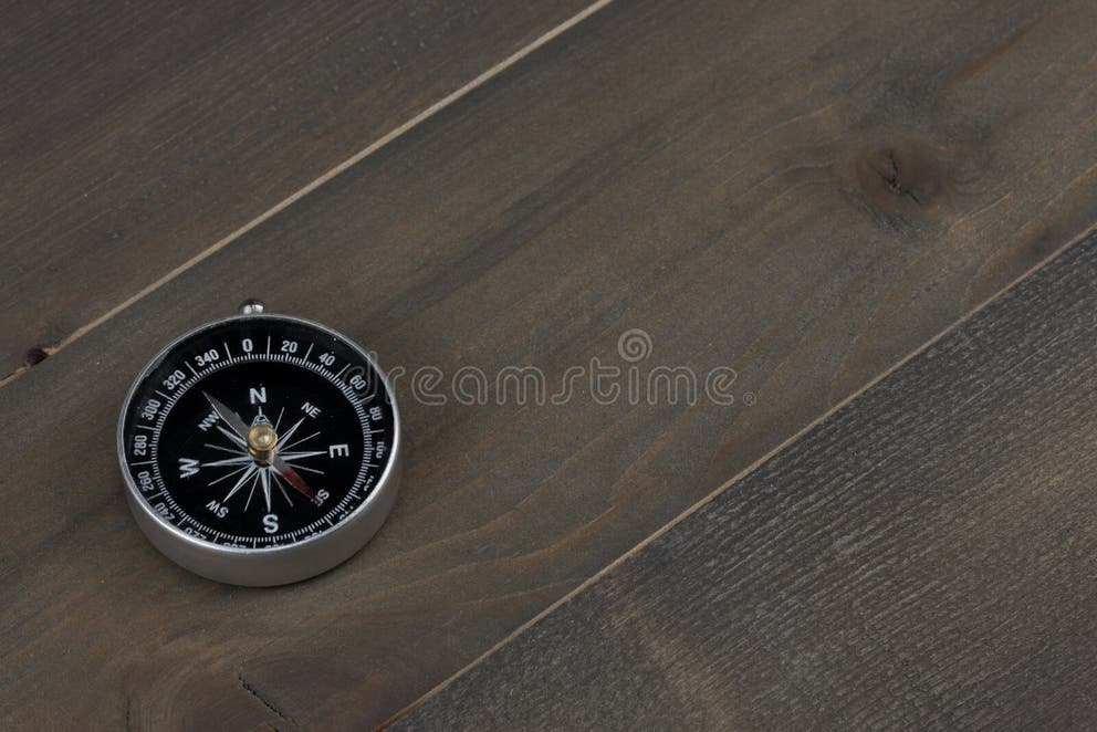 Compass on the wood table stock photo. Image of tourism - 217596492