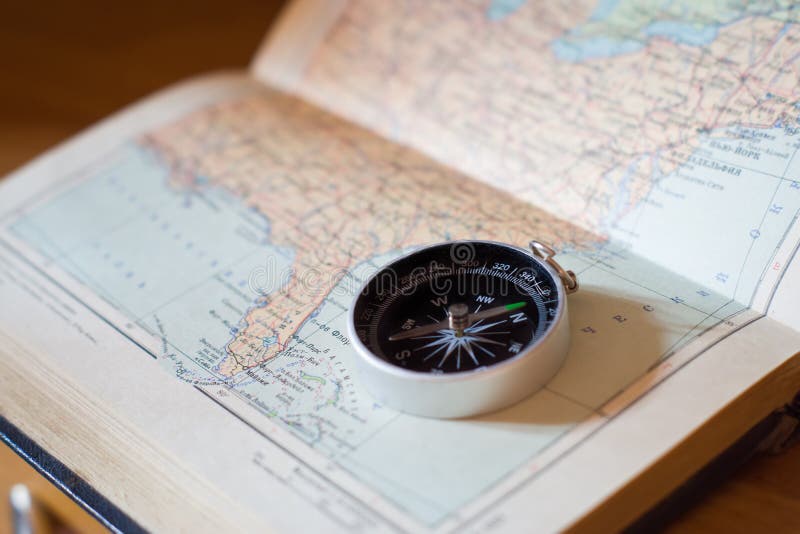 Compass on a road map stock image. Image of road, longitude - 28247439