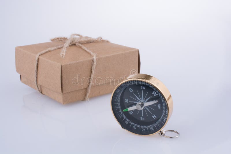 Compass and a Wrapped Gift Box Stock Photo - Image of orientation ...