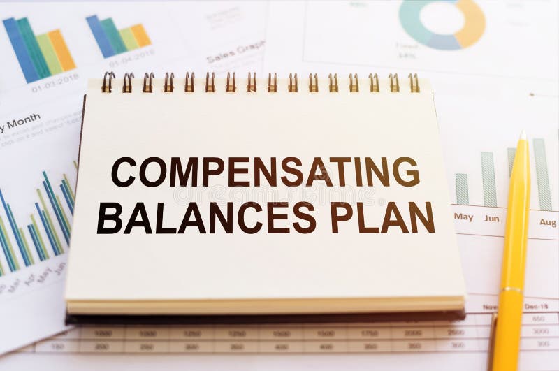 COMPENSATING BALANCES PLAN Written on Notepad on Financial Charts and ...