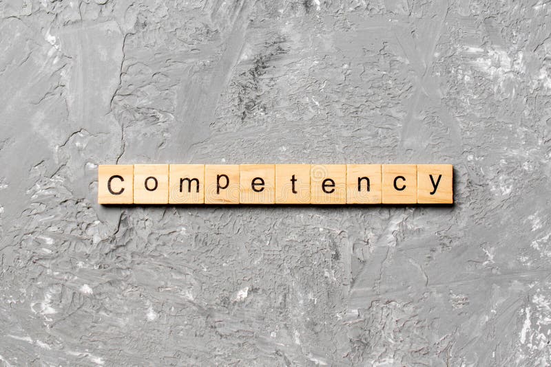 Competency Word Written on Wood Block. Competency Text on Table ...