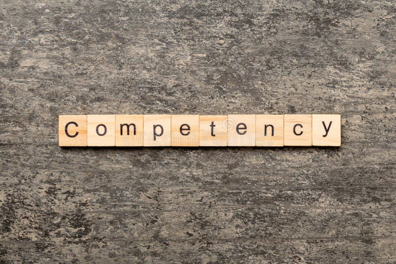 Competency Word Written on Wood Block. Competency Text on Table ...