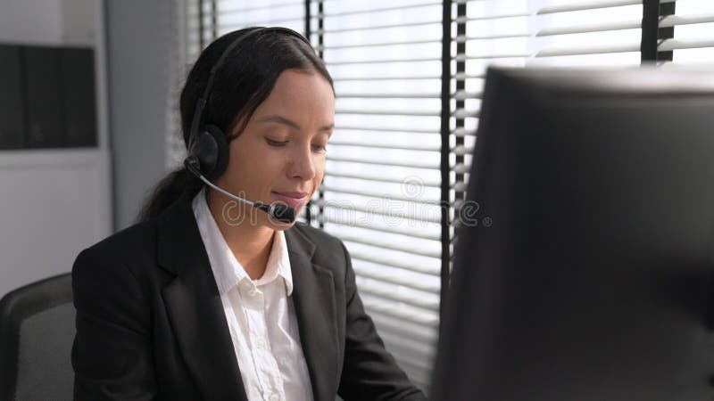 Competent Female Operator Working on Computer and while Talking with ...