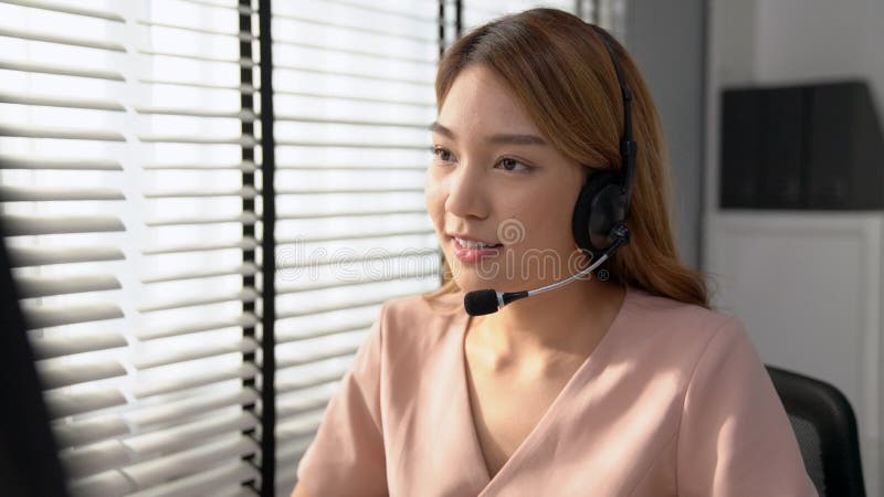 Competent Female Operator Working on Computer and while Talking with ...