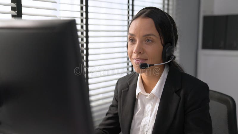 Competent Female Operator Working on Computer and while Talking with ...