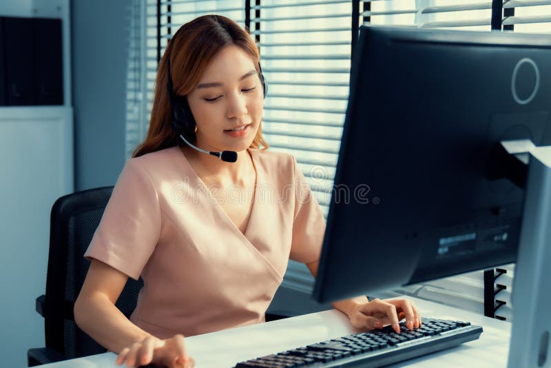 Competent Female Operator Working on Computer and while Talking with ...