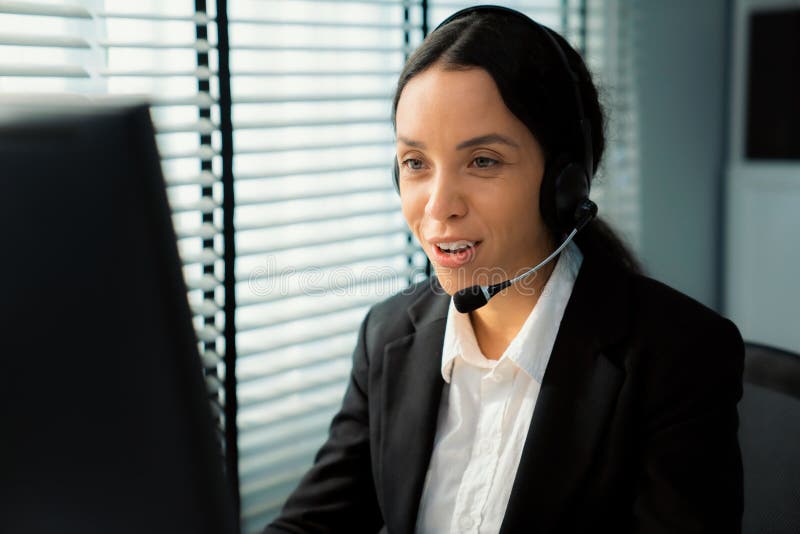 Competent Female Operator Working on Computer and while Talking with ...