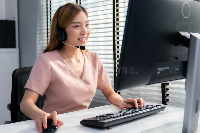 Competent Female Operator Working on Computer and while Talking with ...