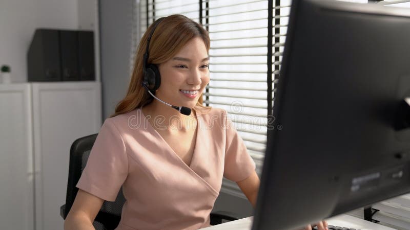 Competent Female Operator Working on Computer and while Talking with ...