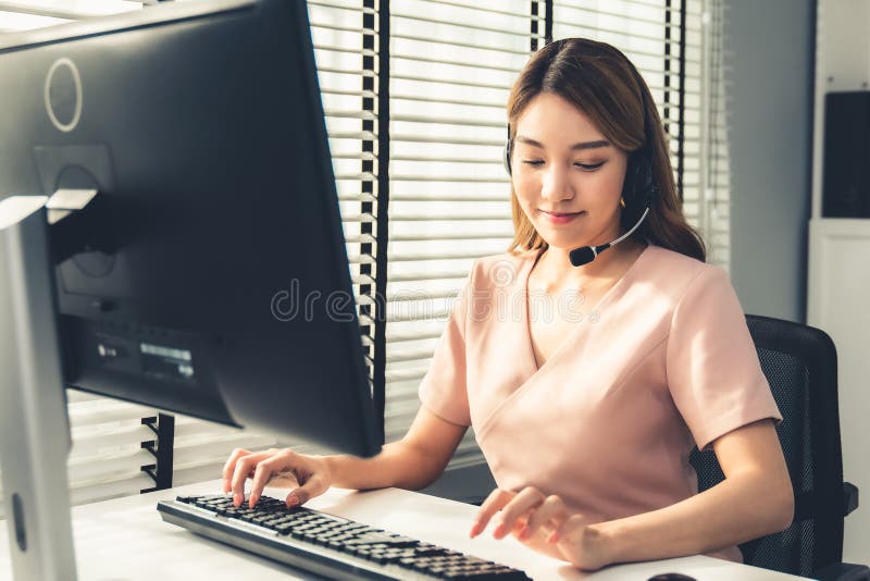 Competent Female Operator Working on Computer and while Talking with ...