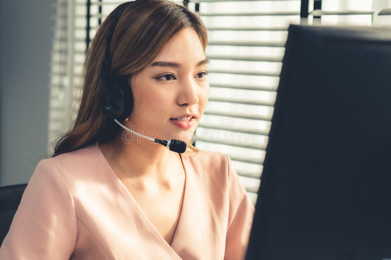 Competent Female Operator Working on Computer and while Talking with ...