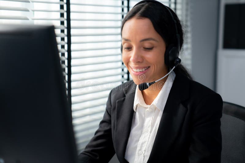 Competent Female Operator Working on Computer and while Talking with ...