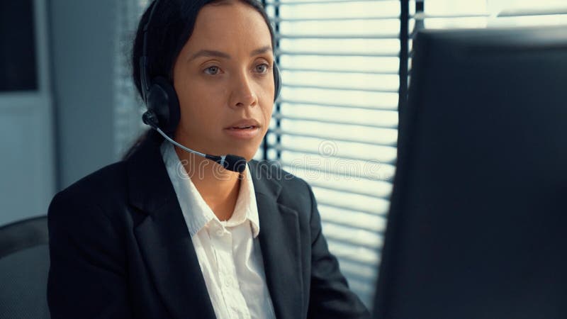 Competent Female Operator Working on Computer and while Talking with ...