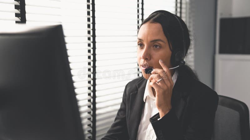 Competent Female Operator Working on Computer and while Talking with ...