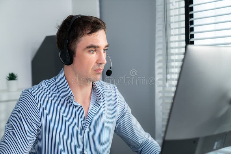 Competent Male Operator Working with Customers in the Office. Stock ...