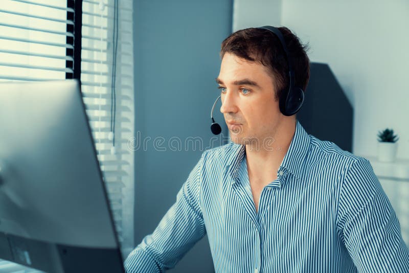 Competent Male Operator Working with Customers in the Office. Stock ...