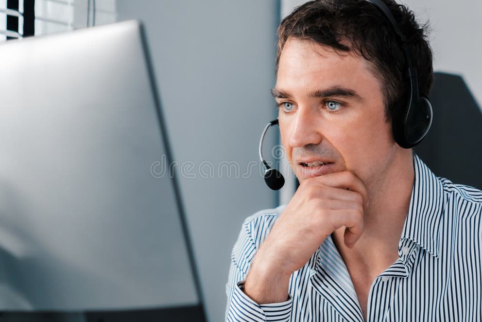 Competent Male Operator Working with Customers in the Office. Stock ...