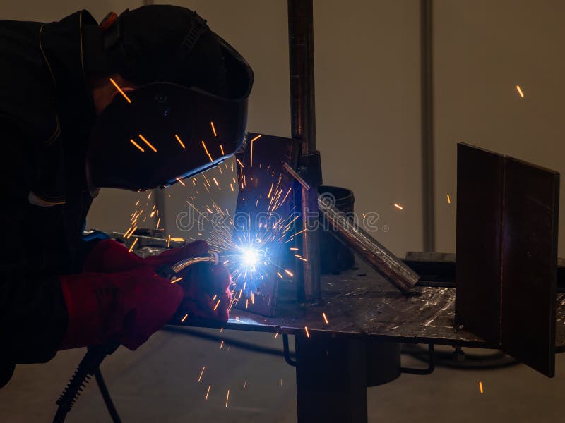 Competitions among Welders. a Man in a Protective Mask is Welding ...