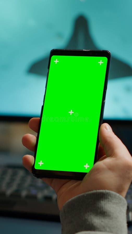 Competitive Gamer Looking at Smartphone with Green Screen Display Stock ...