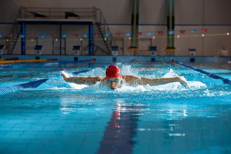 Competitive Swimmer in Red Cap and Goggles in Motion, Training ...