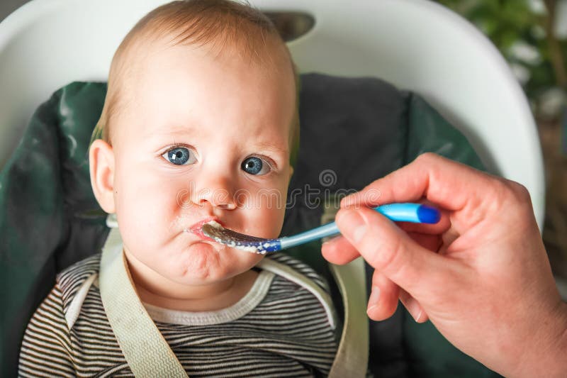 Complementary Feeding of Child, Baby Food. the Infant is Spoon-fed ...