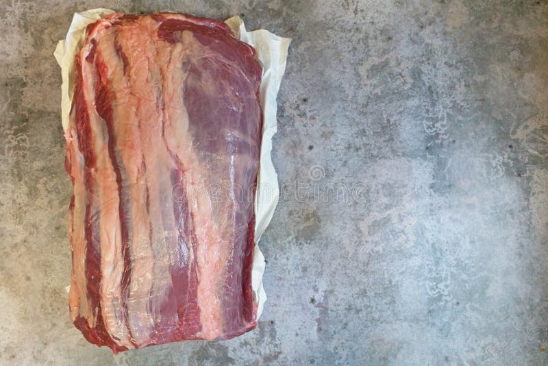 A Fresh, Whole Raw Beef Ribeye Joint Resting on a Marble Table with ...