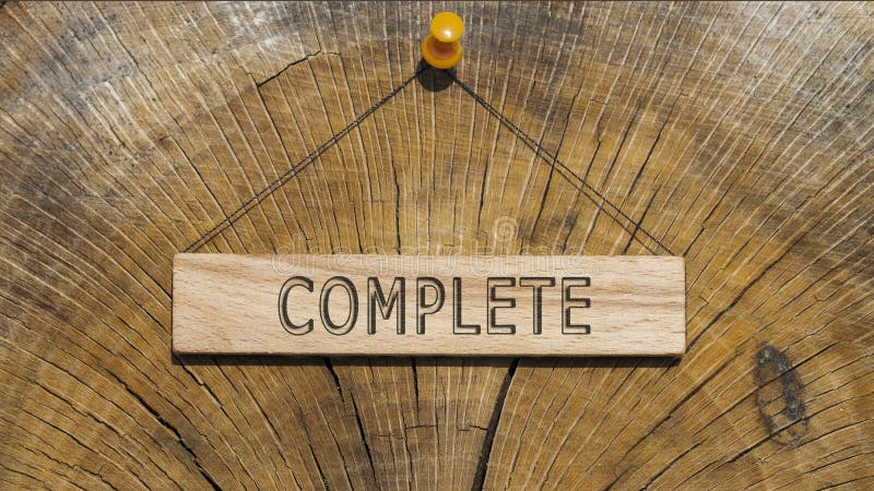 Complete. Written on Wooden Hanging Frame. Background Wood Cut Log ...