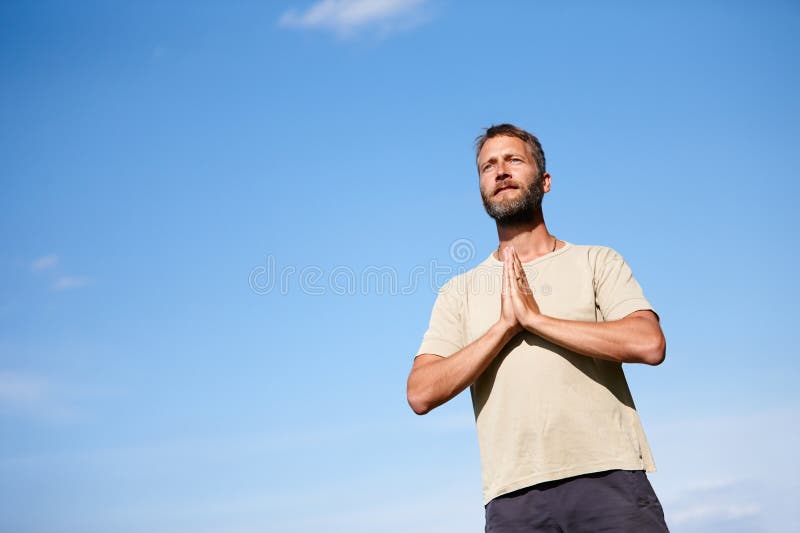 Completely Calm and Relaxed. a Handsome Mature Man Doing Yoga Outdoors ...