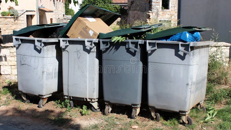 Full Plastic Trash Containers Stock Photo - Image of grass, lids: 99977032