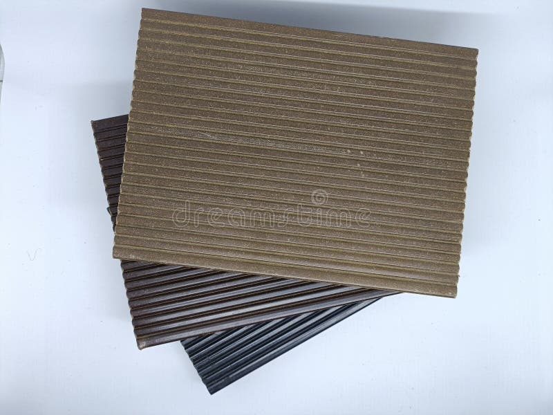 Stack of Composite Decking Boards with Grooved Surface in Various Brown ...