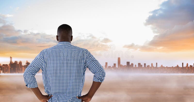 Composite Image of Back of Man Standing in Front of Skyline Stock Photo ...