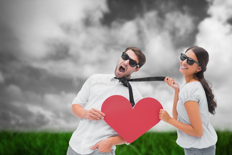 Composite Image of Brunette Pulling Her Boyfriend by the Tie Holding ...