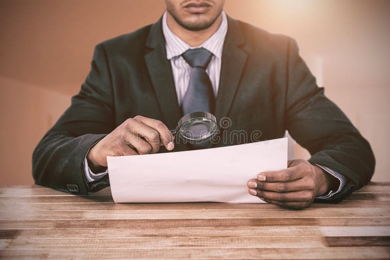 Composite Image of Businessman Looking at Document through Magnifying ...
