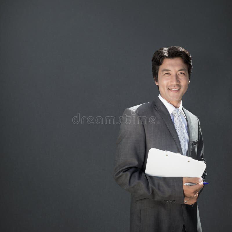 Composite Image of Confident Estate Agent Standing at Front Door with ...