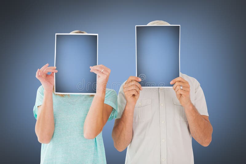 Composite Image of Couple Holding Paper Over Their Faces Stock Image ...