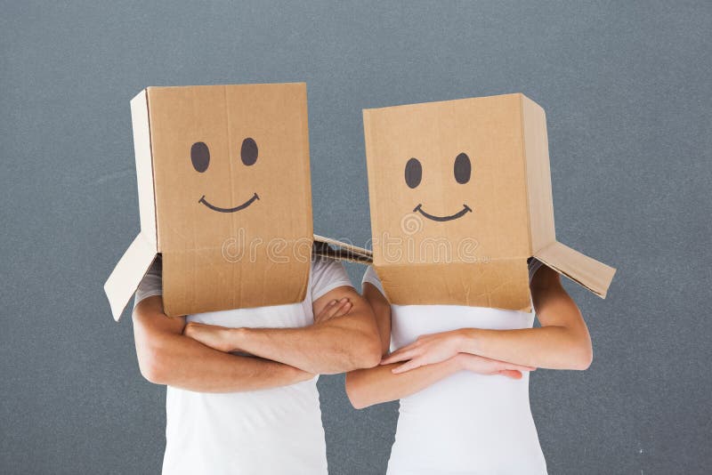 Composite Image of Couple Wearing Smiley Face Boxes on Their Heads ...