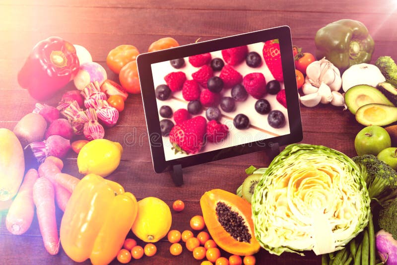 Composite Image of Digital Tablet Surrounded with Fresh Fruits and ...