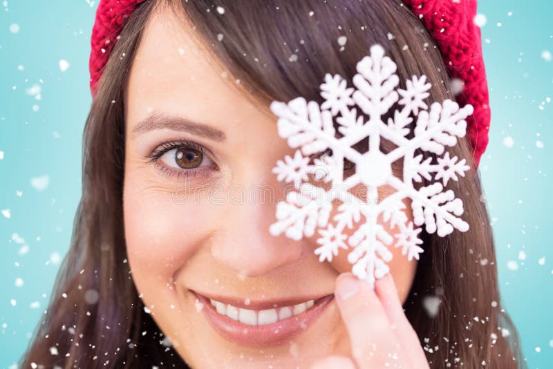 Composite Image of Festive Brunette Holding Snowflake Decoration Stock ...