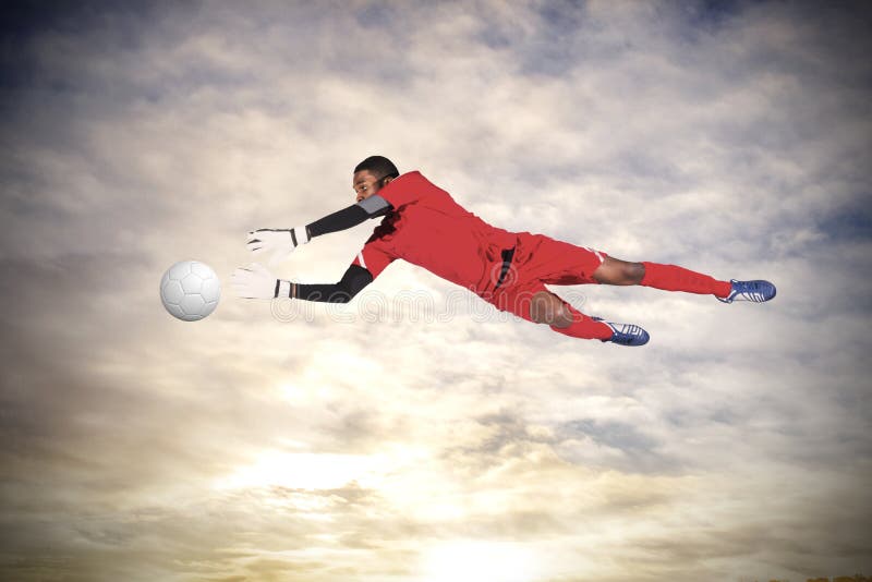 Composite Image of Goalkeeper in Red Making a Save Stock Image - Image ...