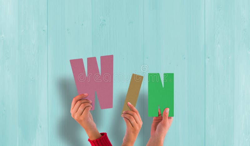 A Composite Image of Hands Holding Up Win Stock Image - Image of wooden ...