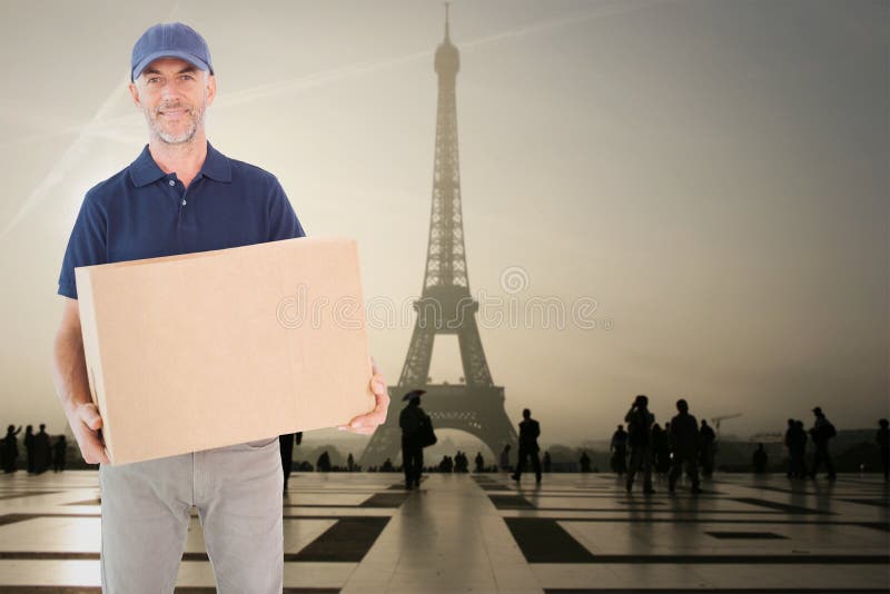 Composite Image of Happy Delivery Man Holding Cardboard Box Stock Photo ...