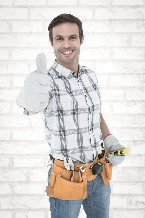 Composite Image Of Happy Handyman Gesturing Thumbs Up Stock Photo ...