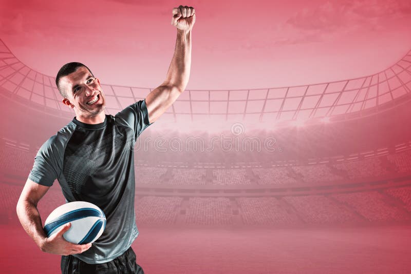 Happy Rugby Player Holding Ball with Arms Raised Against Blue Sky Stock ...
