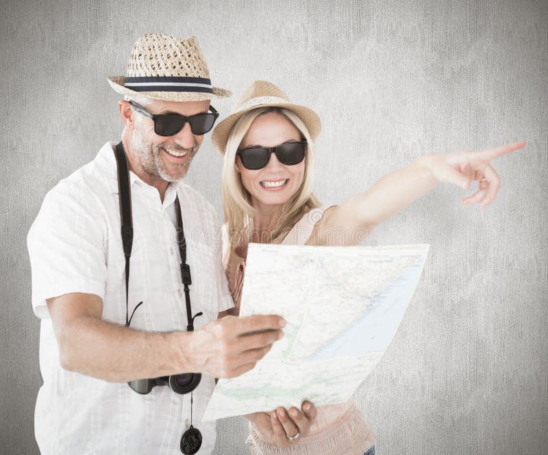 Composite Image of Happy Tourist Couple Using Map and Pointing Stock ...