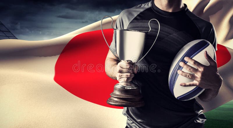 Composite Image of Midsection of Successful Rugby Player Holding Trophy ...