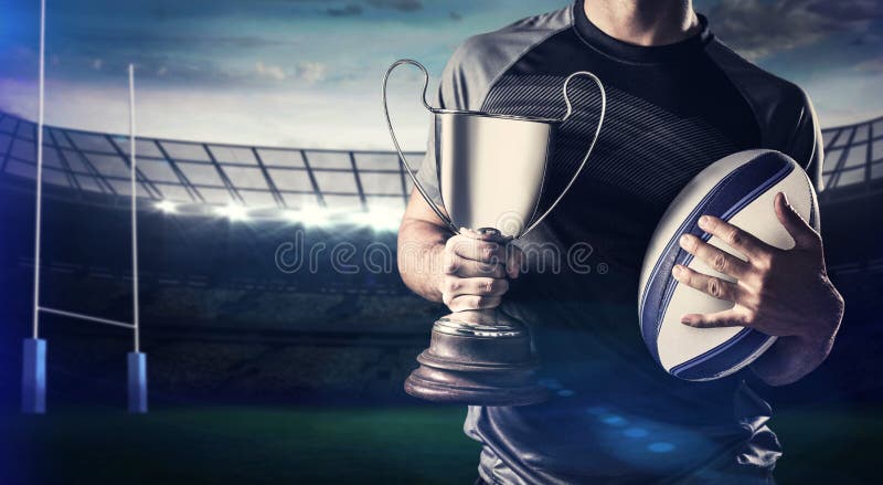 Composite Image of Midsection of Successful Rugby Player Holding Trophy ...