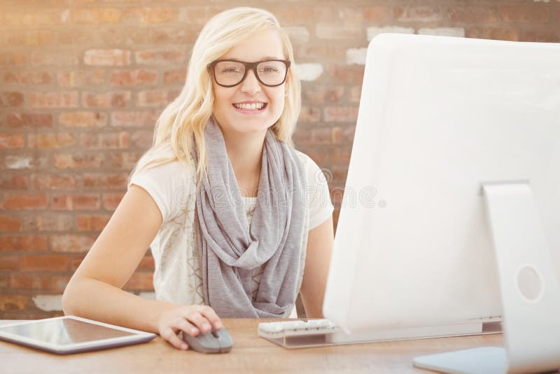 Composite Image of Portrait of Smiling Woman Using Computer Stock Photo ...