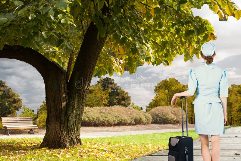 Composite Image of Pretty Air Hostess Leaning on Suitcase Stock Photo ...
