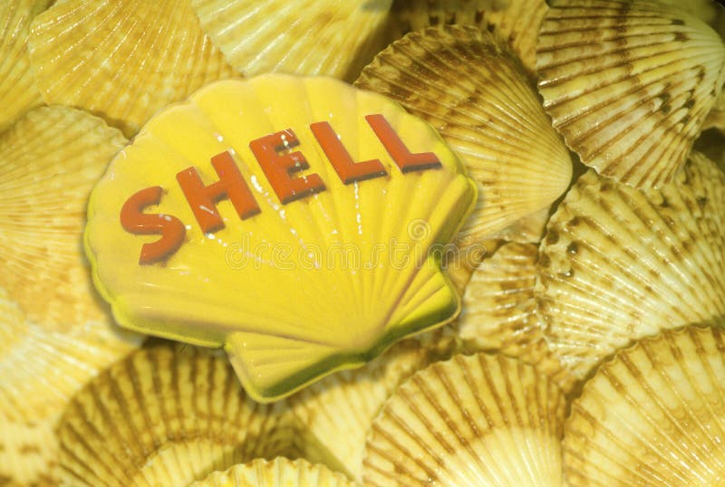 Composite Image of Shell Oil Company Sign Over a Bed of Seashells ...